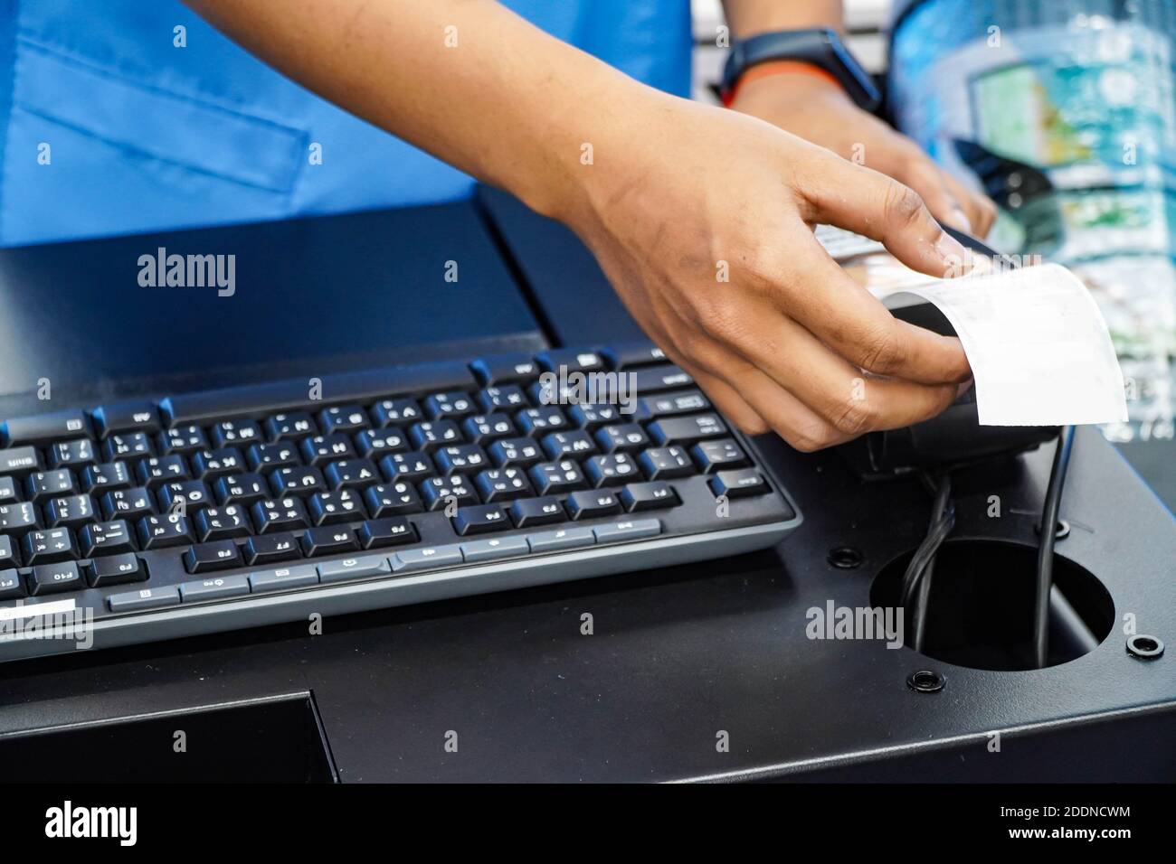 Hand holding the receipt from the credit card swipe machine .Pay with a ...