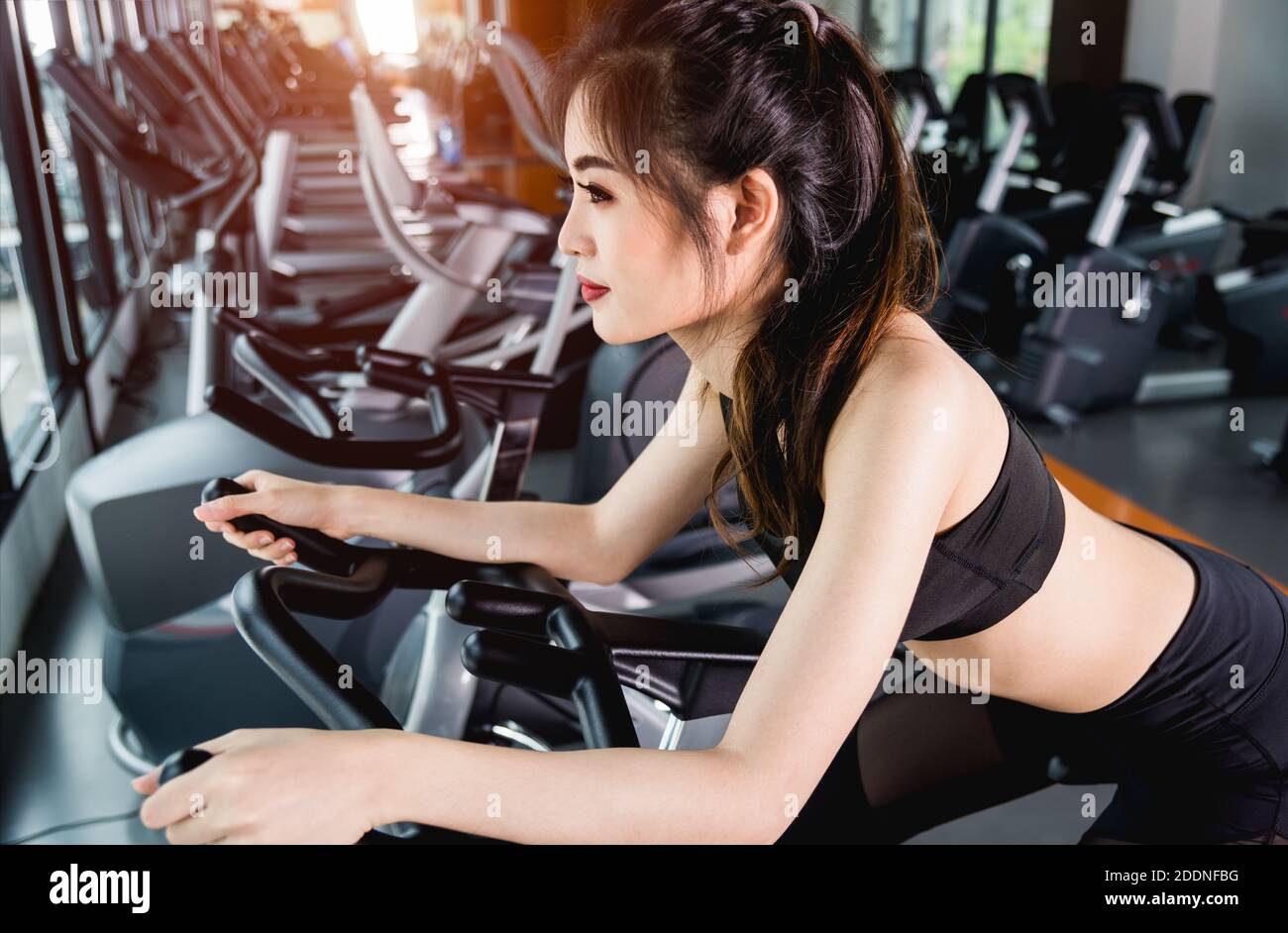 Female lifestyle using equipment exercise bike for training cardio ...