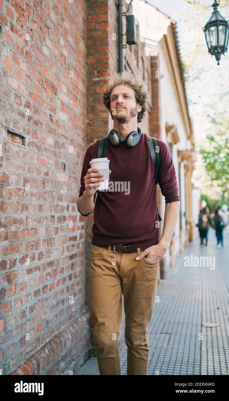 Young man walking on the street Stock Photo - Alamy