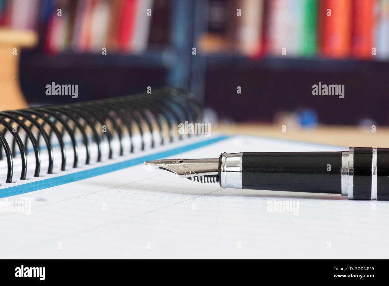A fountain pen and books in the background Stock Photo - Alamy