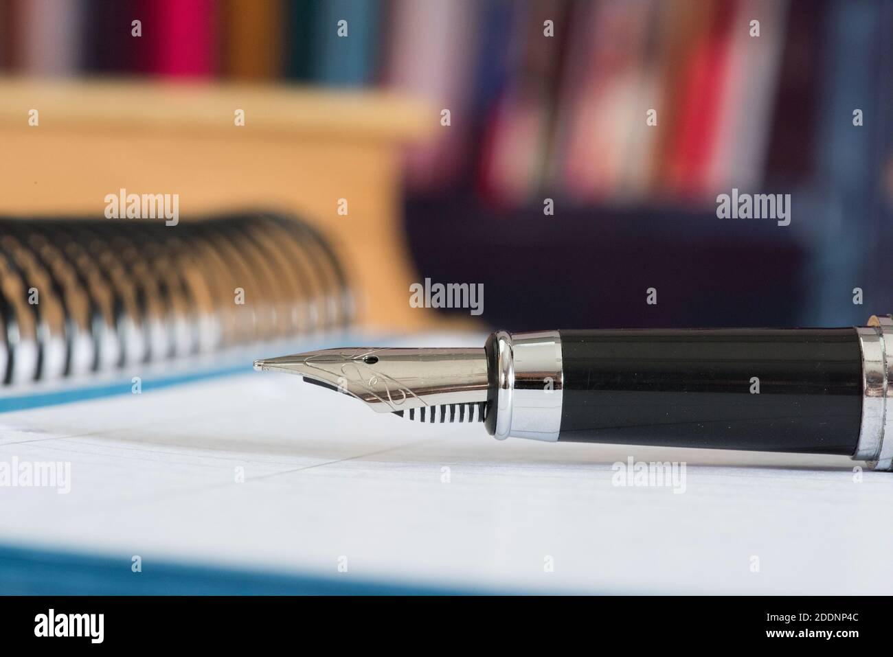 A fountain pen and books in the background Stock Photo - Alamy