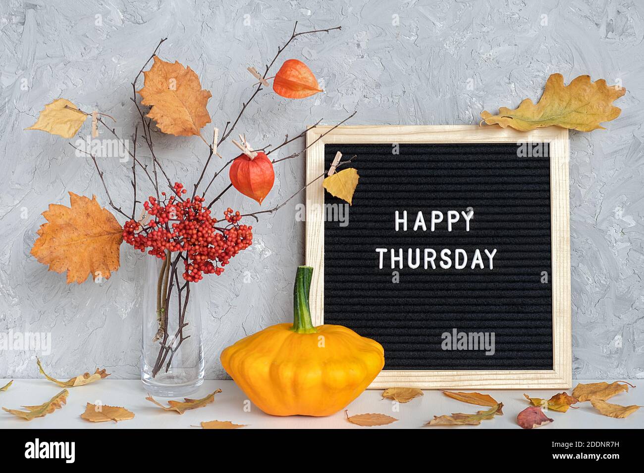 Happy Thursday text on black letter board and bouquet of branches with ...