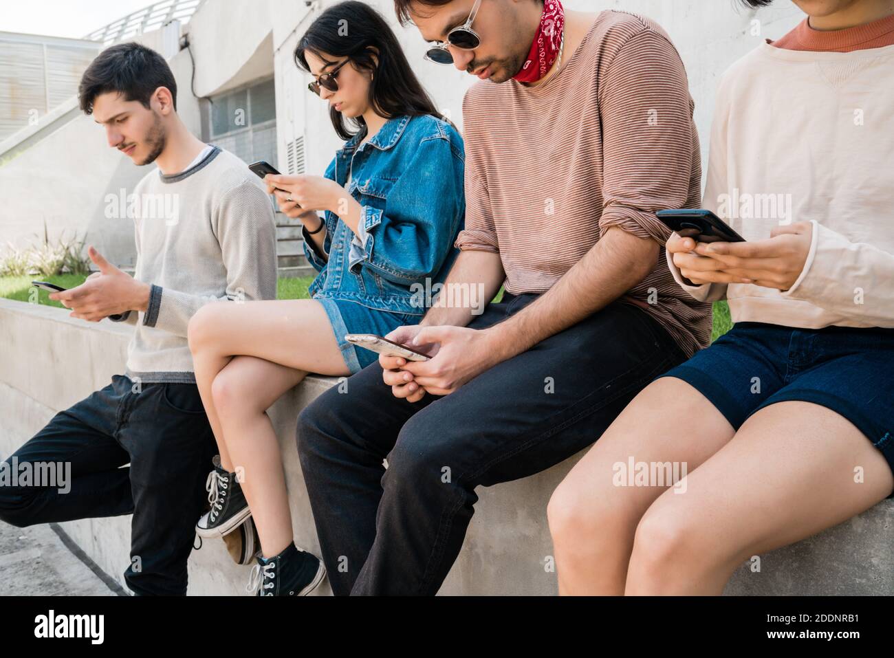 Group of friends using their phones Stock Photo - Alamy