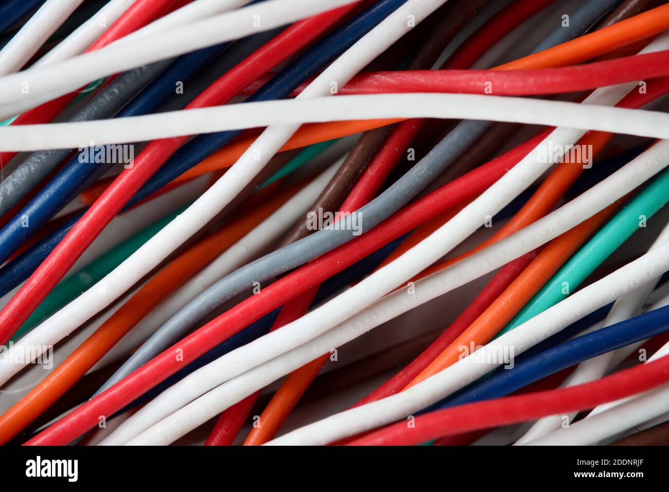 Many multi-colored wires lying in workshop closeup background Stock ...