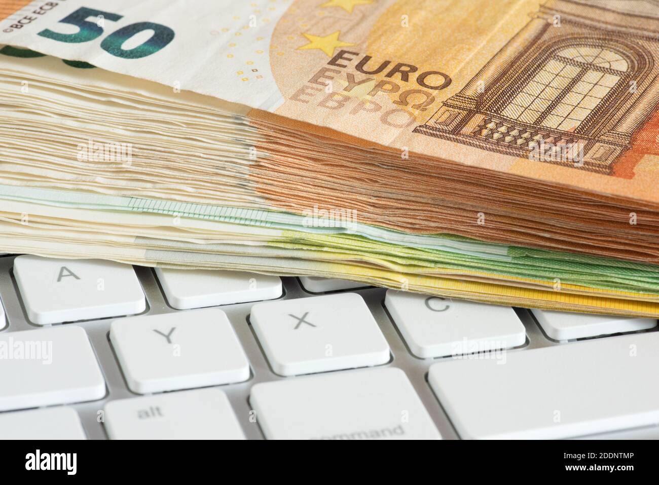 Euro banknotes and a computer Stock Photo - Alamy