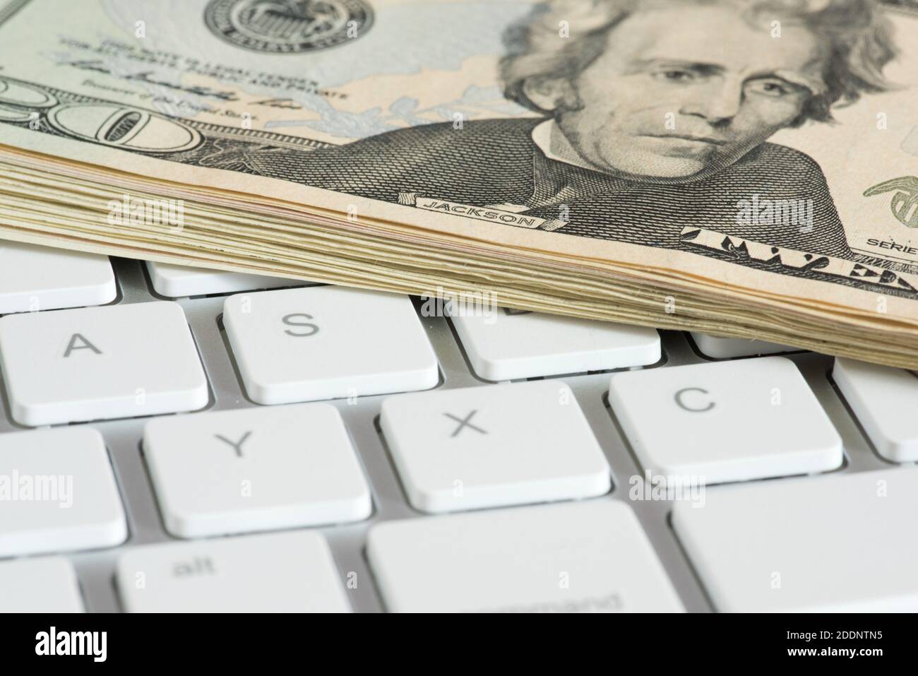 Dollar bills and a computer Stock Photo - Alamy