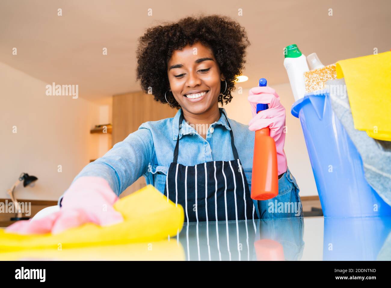 Afro woman cleaning new home Stock Photo - Alamy