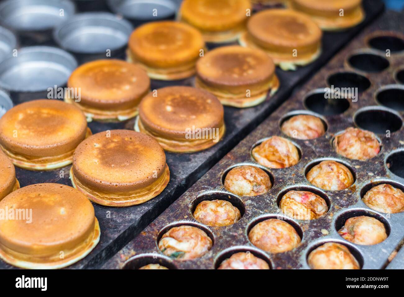 Takoyaki and taiko manju at the Kuromon Ichiban market in Osaka, Japan ...