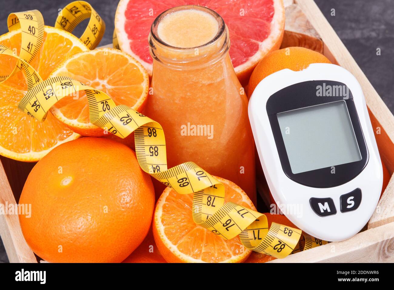 Glucometer, healthy smoothie from citrus fruits and tape measure. Food ...