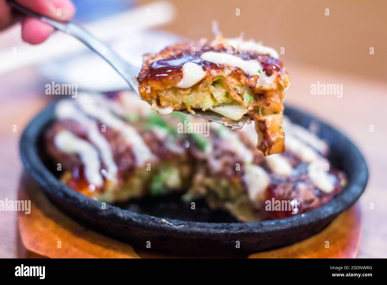 Okonomiyaki is a popular local food in Osaka, Japan Stock Photo - Alamy