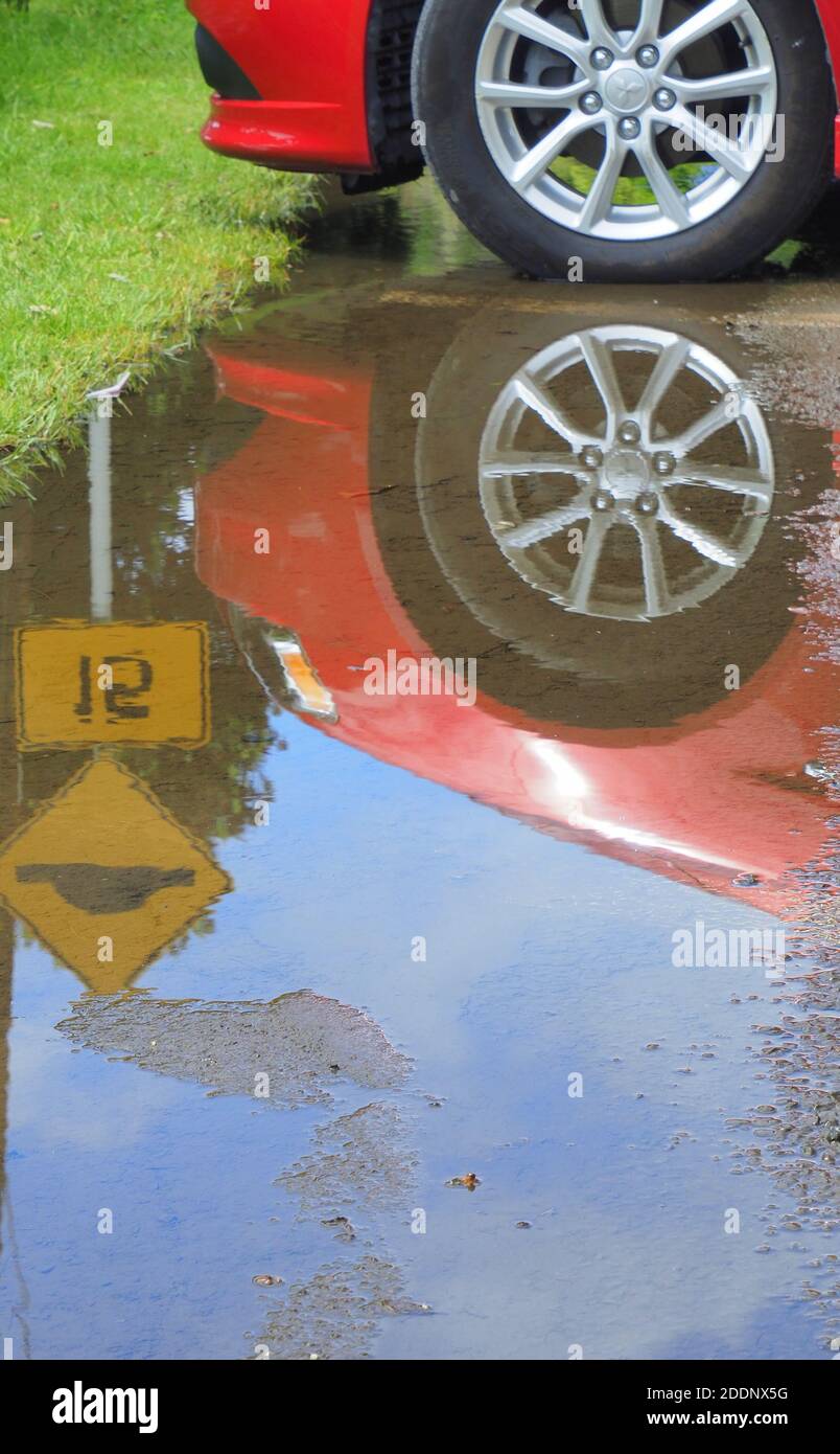 Parked car reflected in puddle hi-res stock photography and images - Alamy