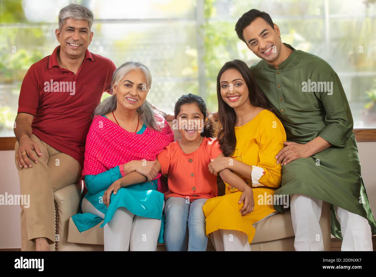 Portrait of a joint family in the living room Stock Photo - Alamy