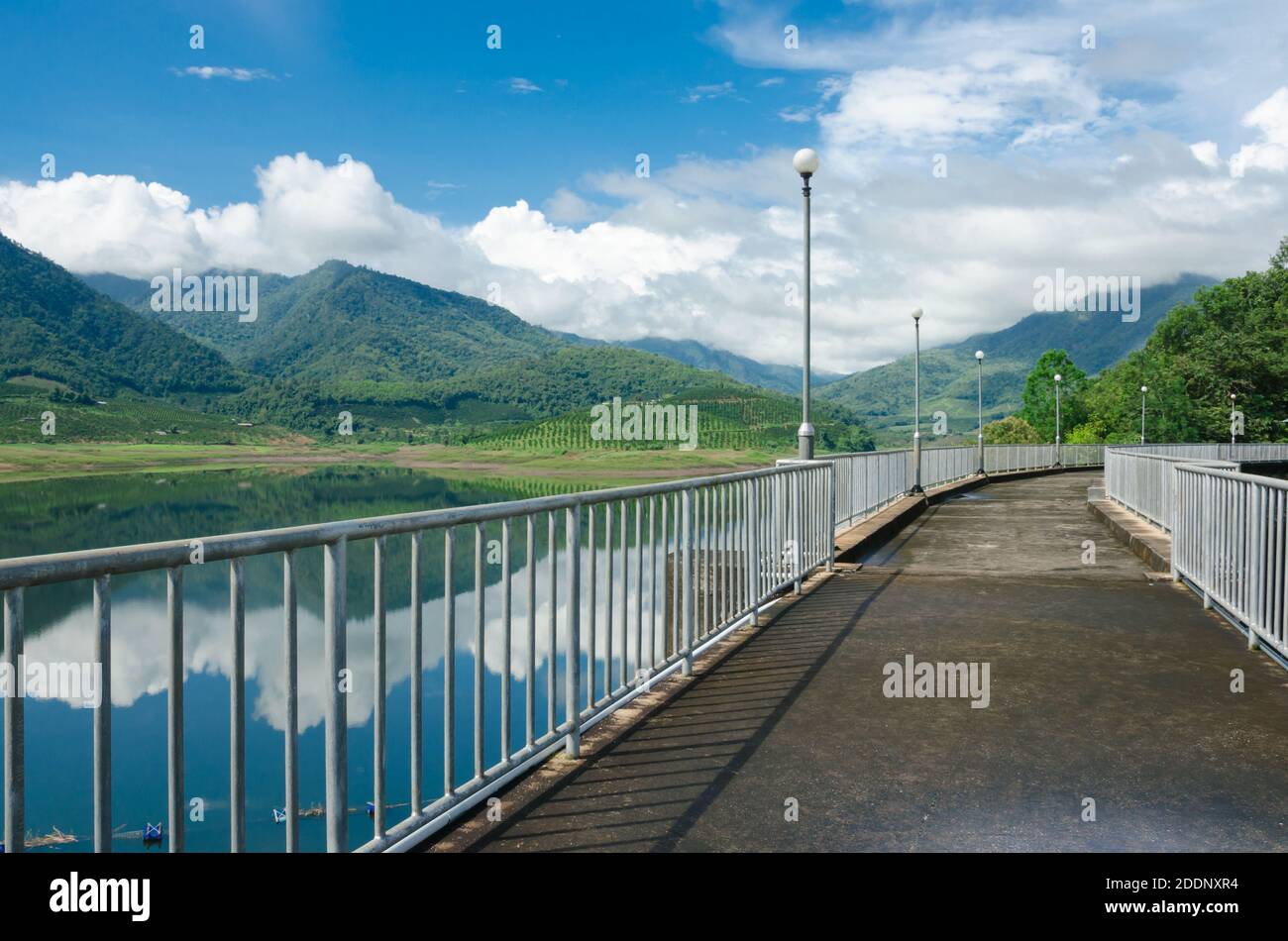 pathway on top of dam for overlooking the water and mountains Stock ...