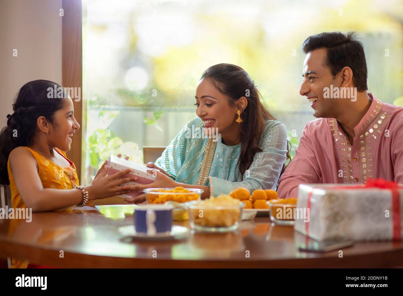 mother receiving a gift from her daughter during celebrations Stock ...