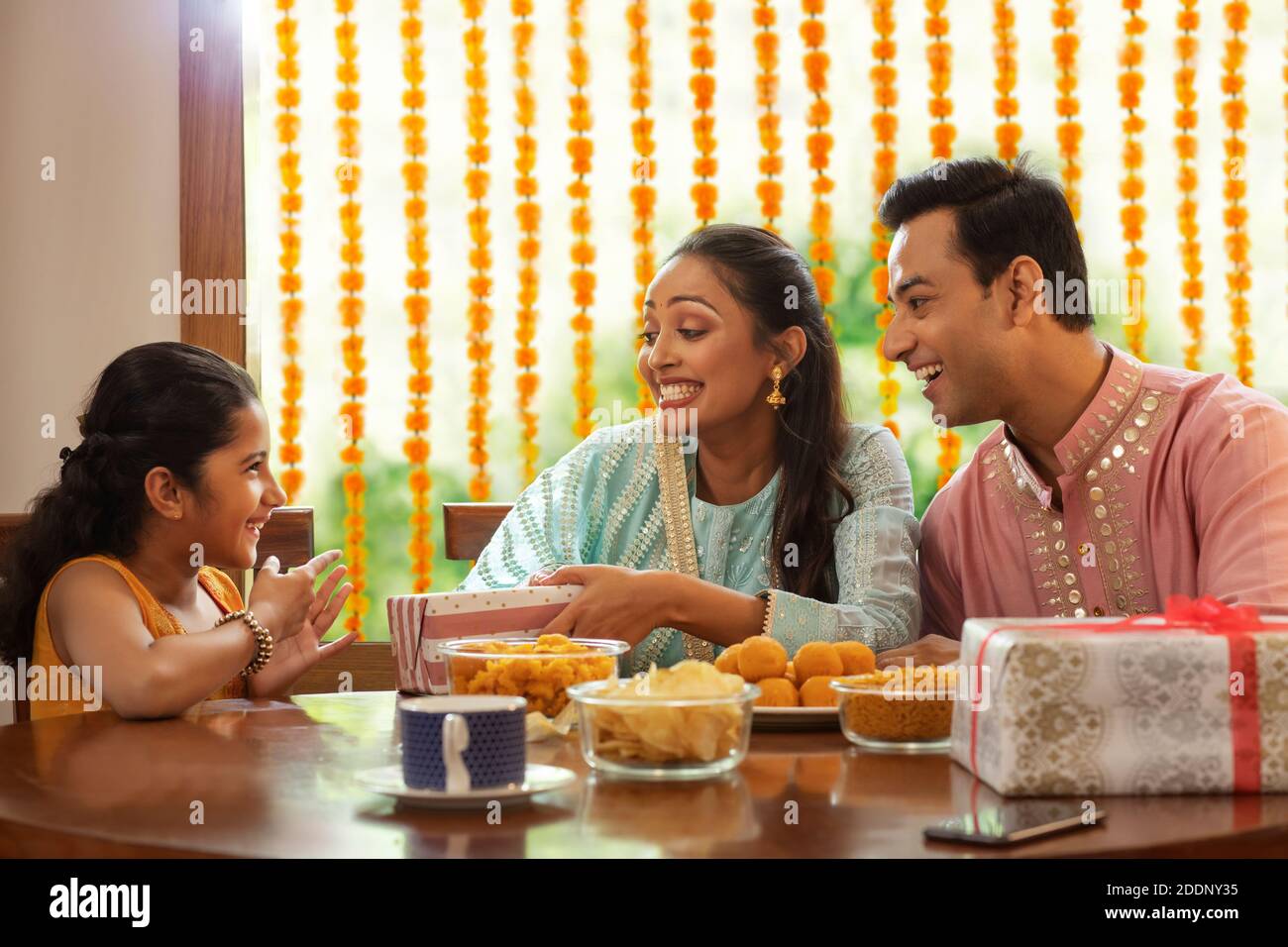 mother receiving a gift from her daughter during celebrations Stock ...