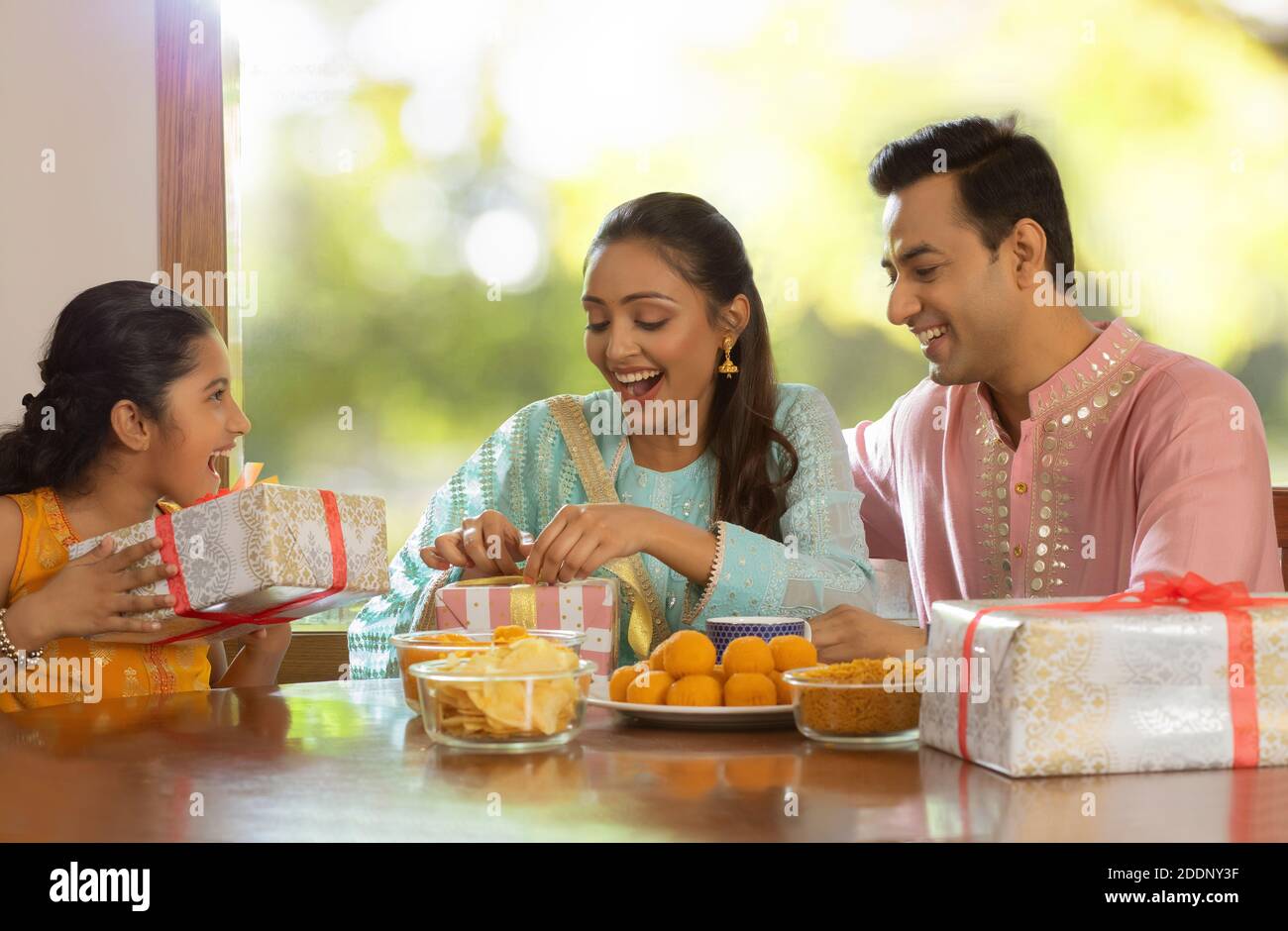 mother receiving a gift from her daughter during celebrations Stock ...