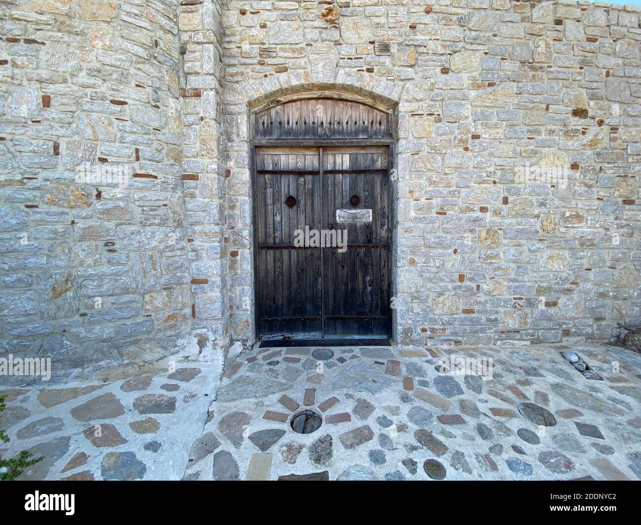 Medieval wooden heavy door on a stone wall. Stone strong walls and ...