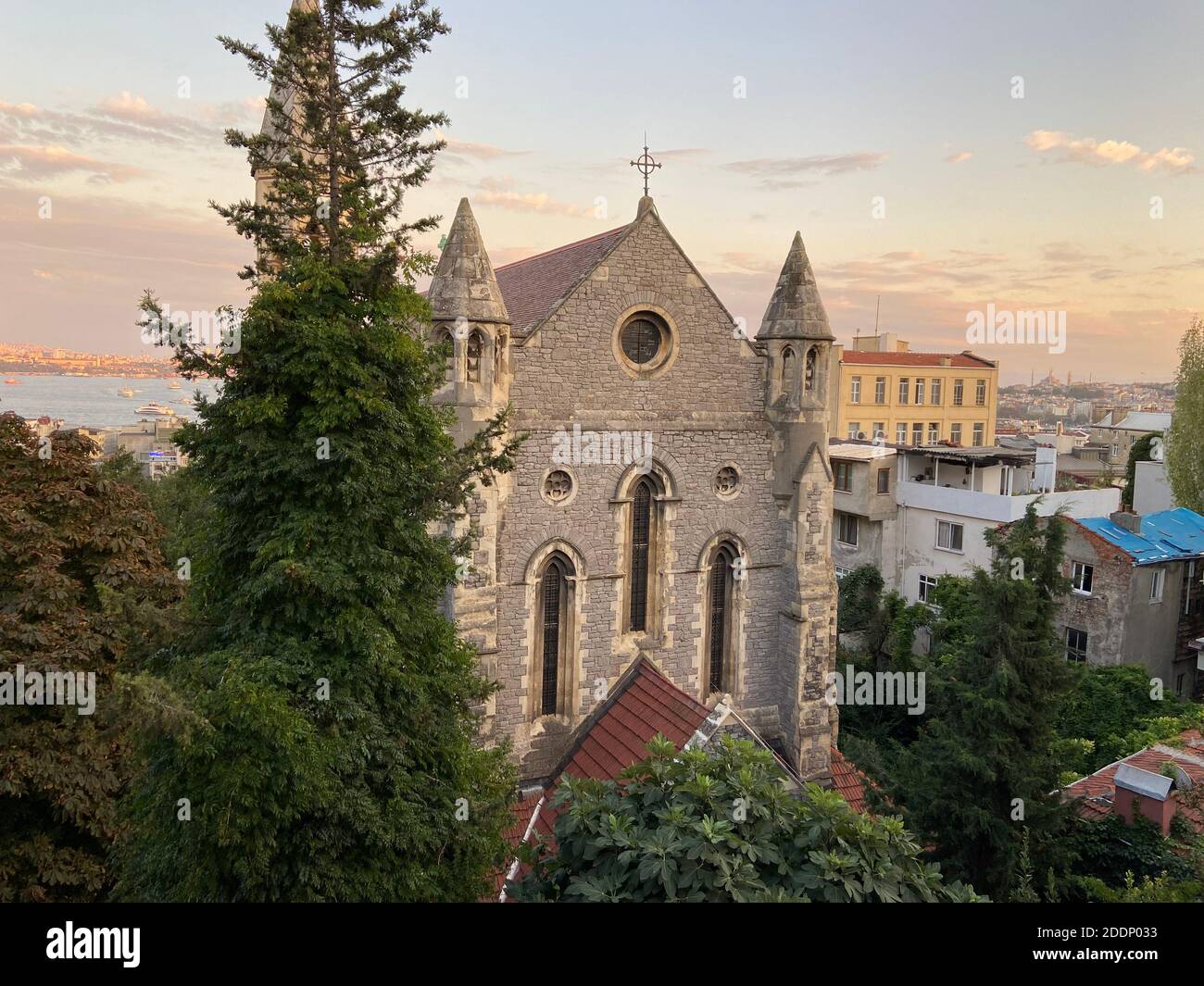Old vintage medievel stone church building surrounded with trees ...