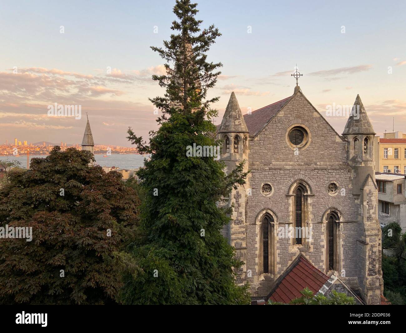 Old vintage medievel stone church building surrounded with trees ...