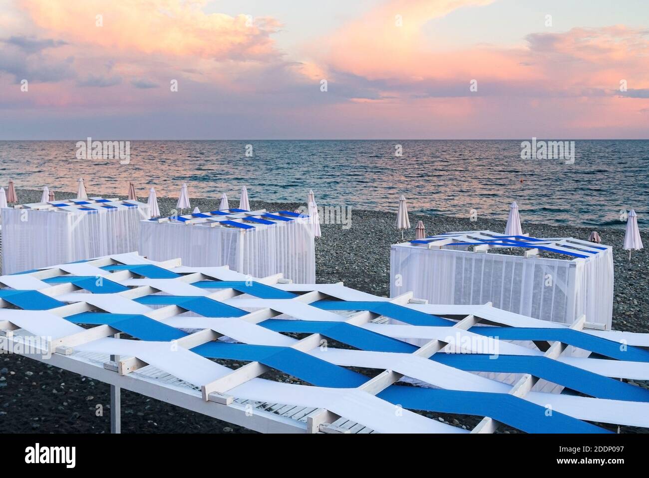 Beach canopies with sun loungers and umbrellas by the sea Stock Photo ...