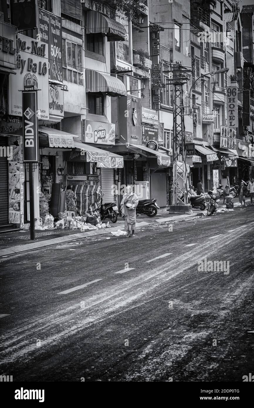 A buddhist monk alone in the street walking barefooted Stock Photo - Alamy