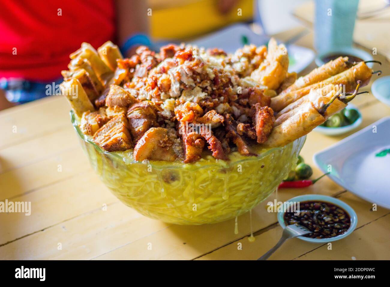 An overloaded noodle dish locally called lomi brimming with toppings at ...