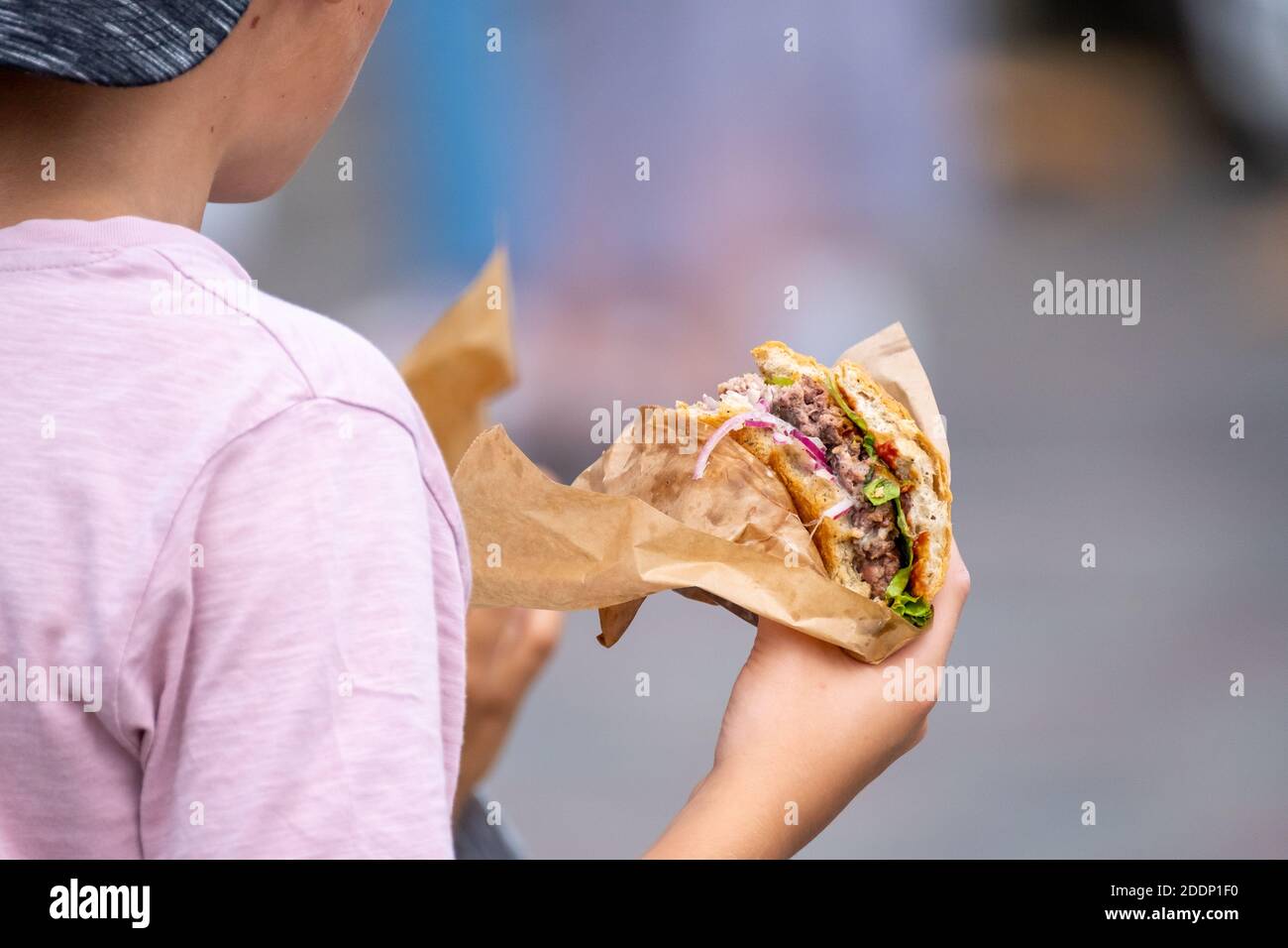 Anonymous child with delicious burger Stock Photo - Alamy