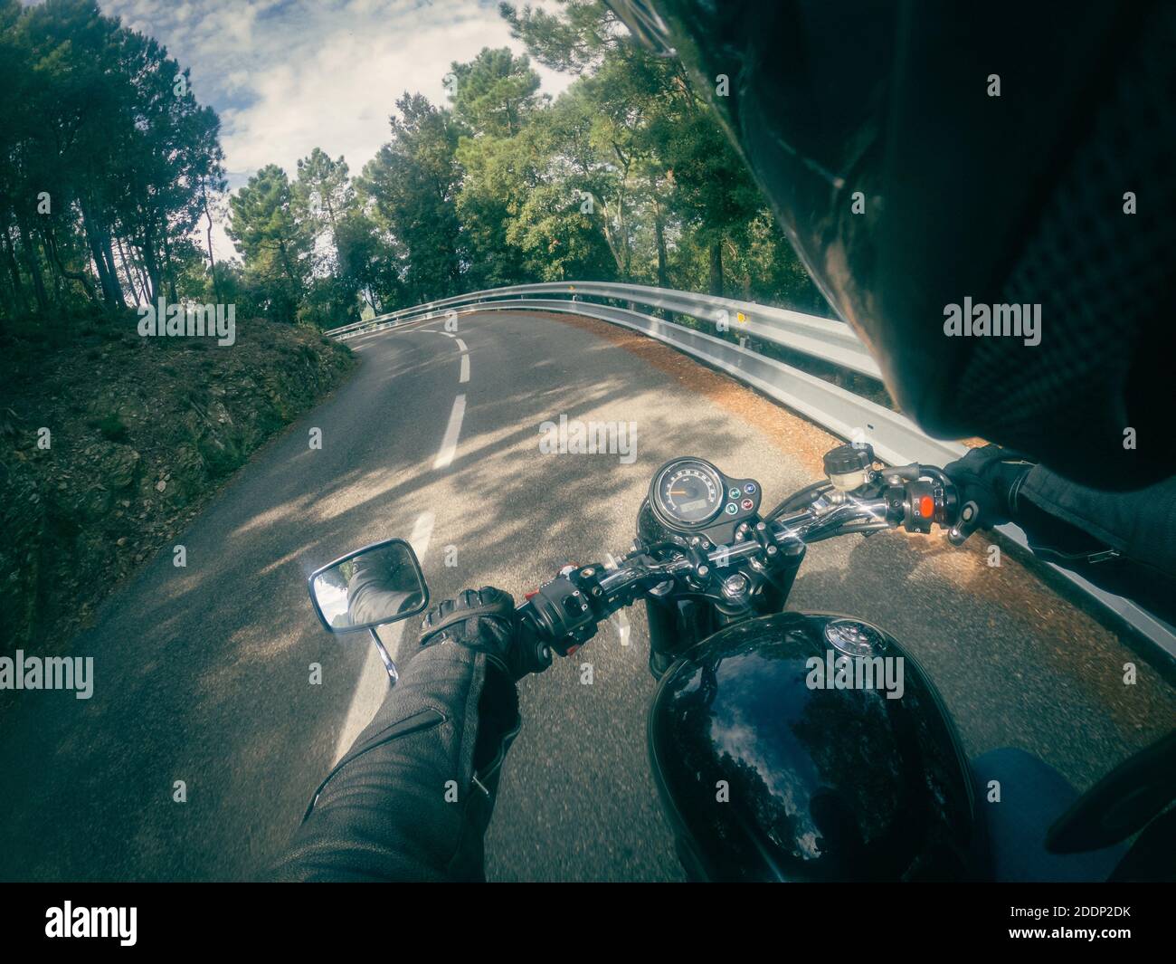Riding a retro old black motorbike rider point of view on a winding ...