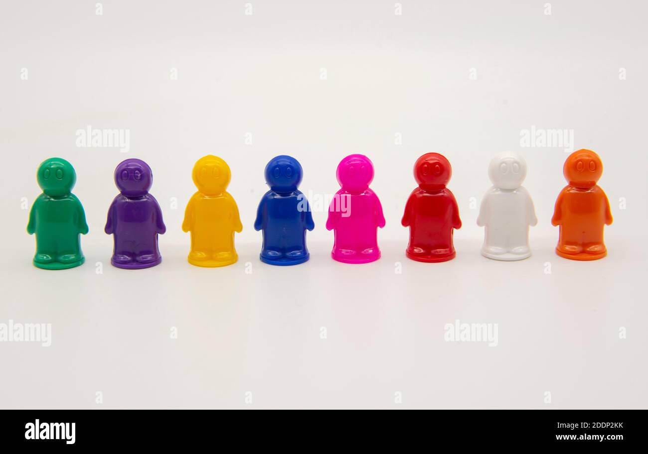Miniature toy figures stand in formation on a white background Stock ...