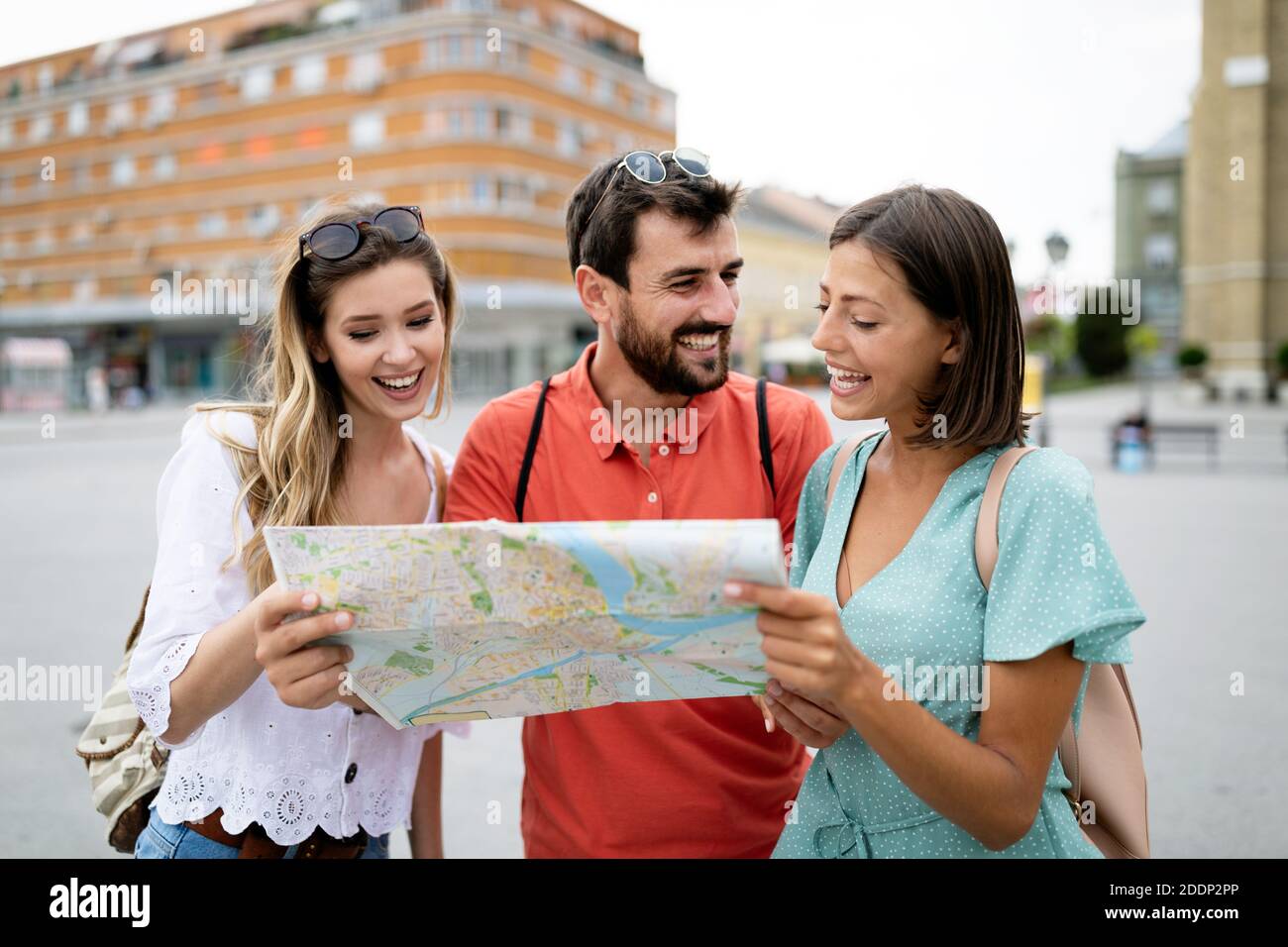 Happy friends enjoying sightseeing tour in the city Stock Photo - Alamy