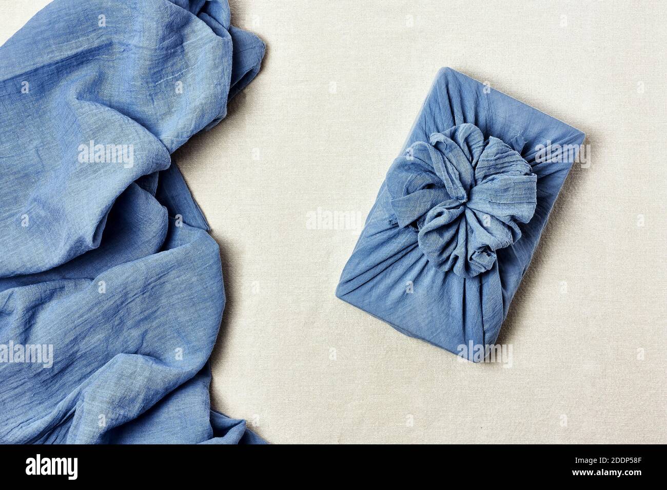 Trendy gift box wrapped in traditional Japanese furoshiki style on ...