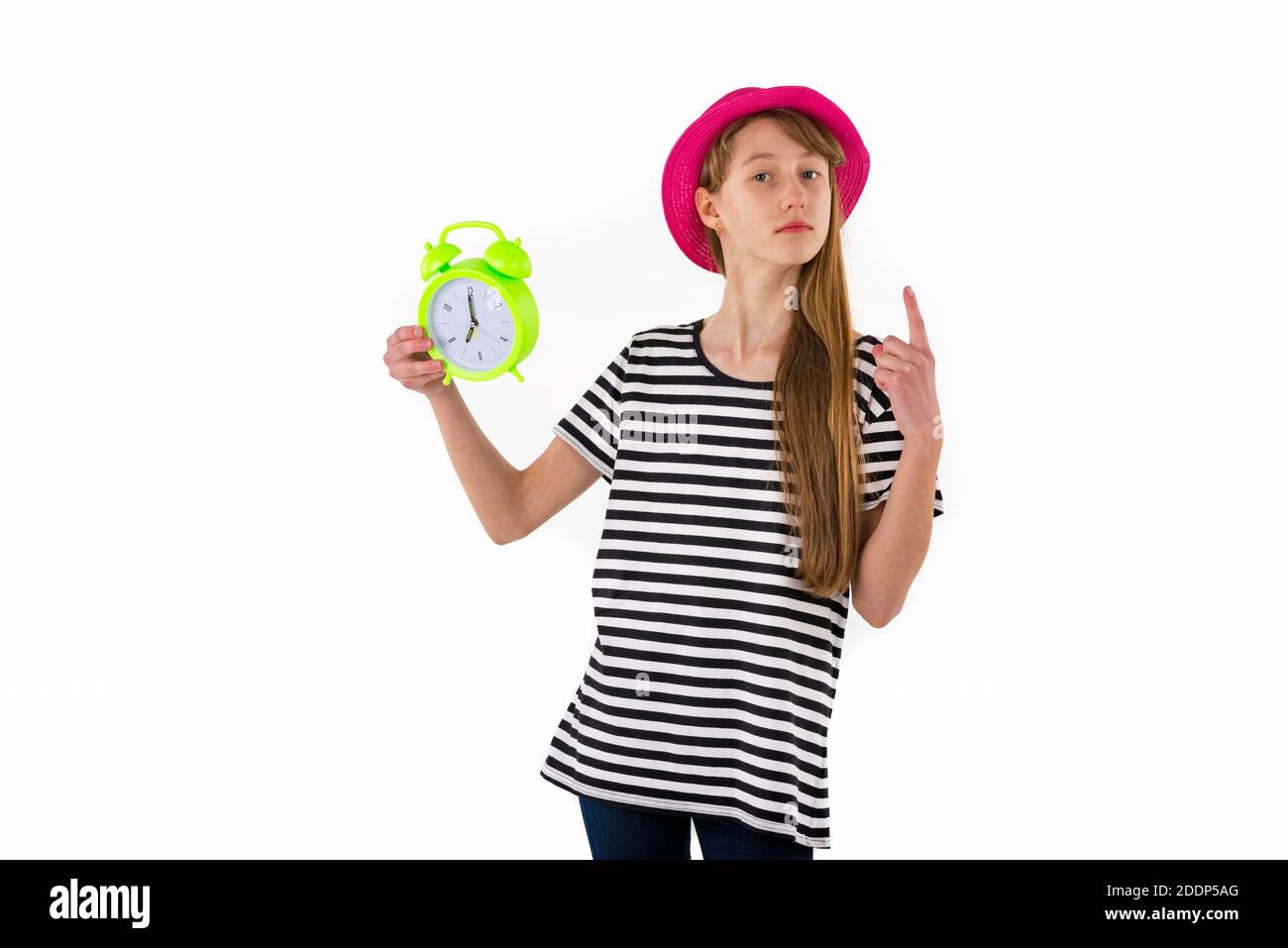 Teen Girl holding alarm Clock, isolated on white background. Portrait ...