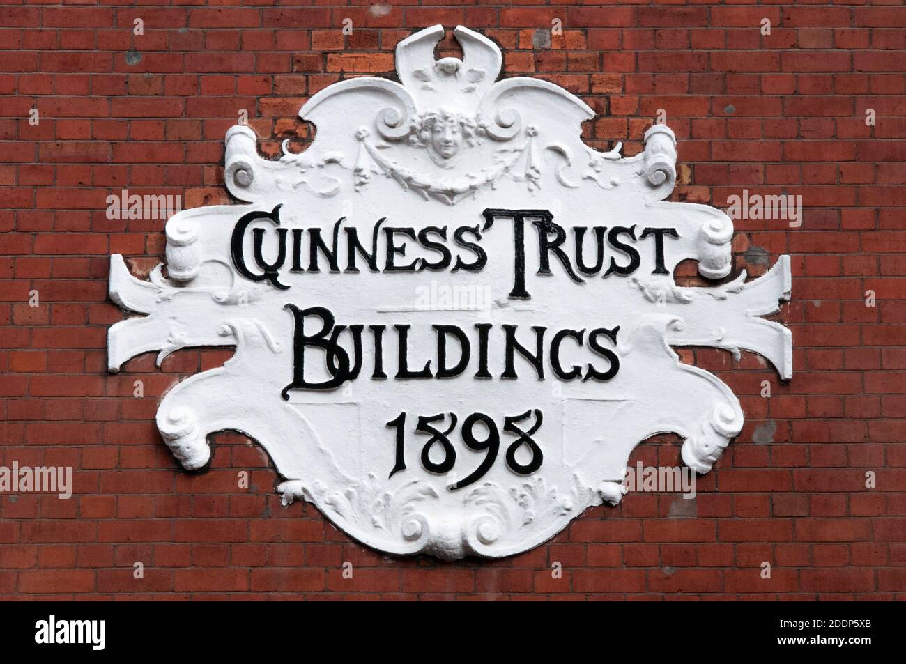A Flamboyant Sign On The Red Brick Exterior Wall Of A Block Of Guinness ...