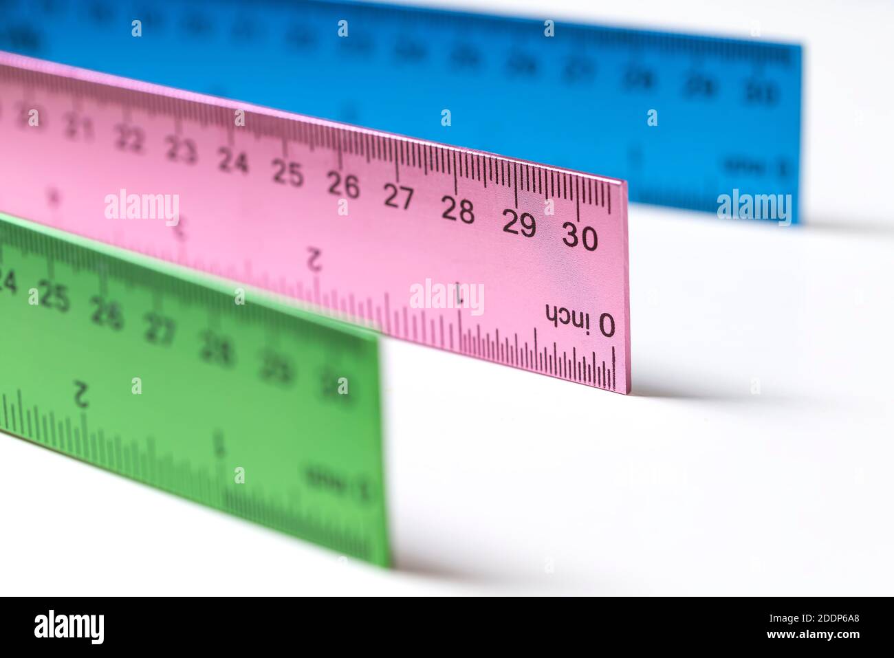 Colorful Metal rulers on white tabletop product Stock Photo - Alamy