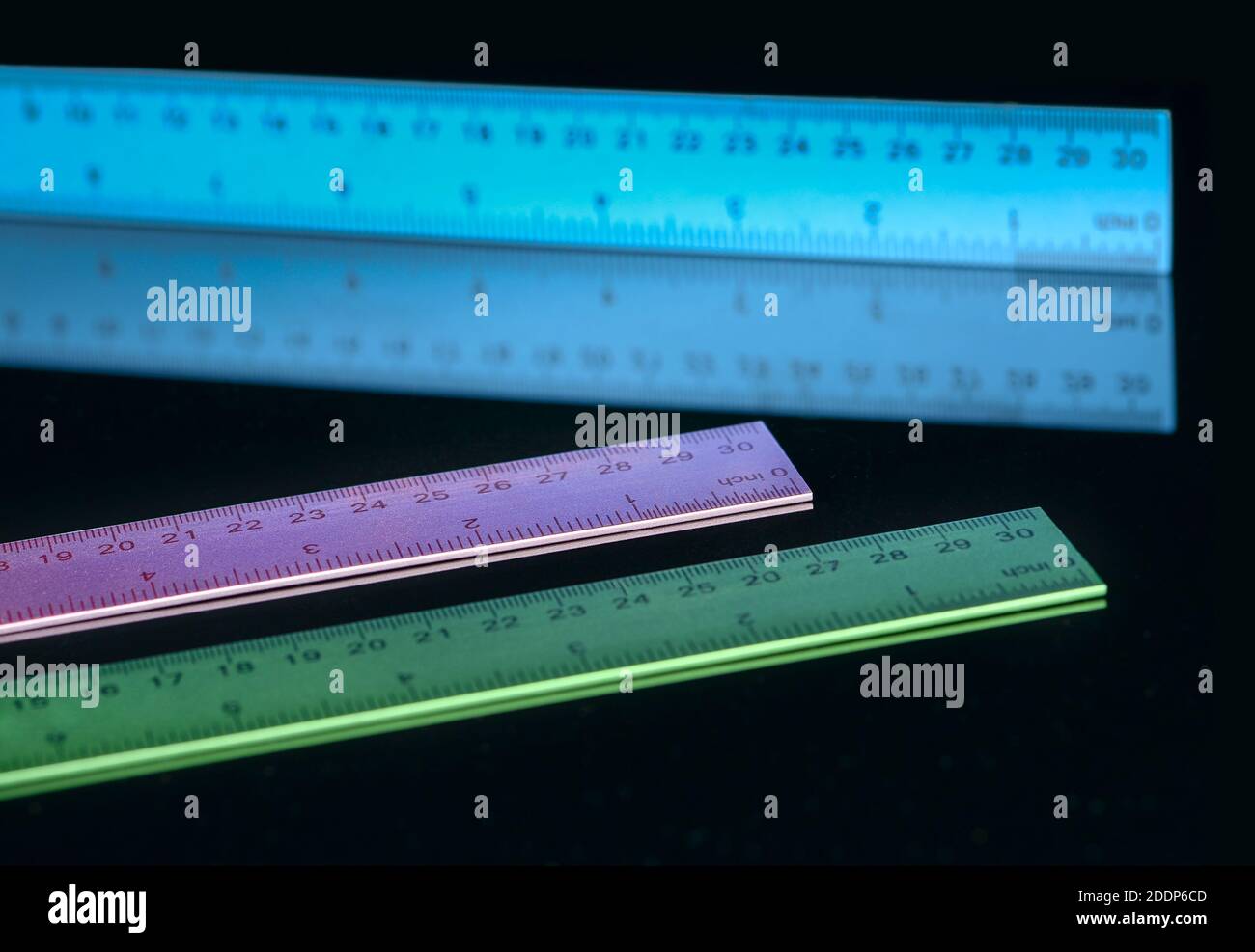 Workshop colored metal rulers on black glass table Stock Photo - Alamy