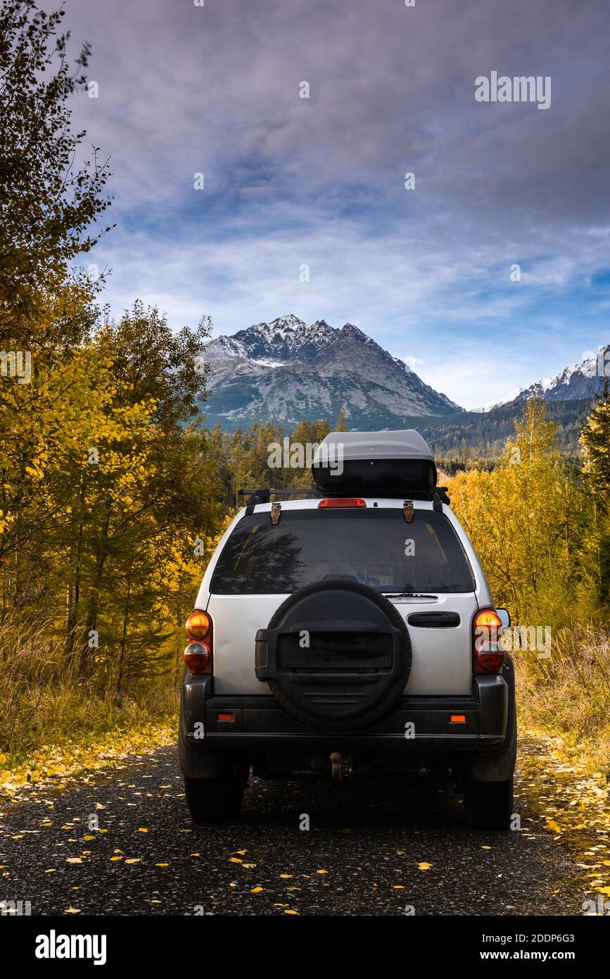 Off Road Car in Autumn Forest in High Mountains. Outdoors Adventure and ...