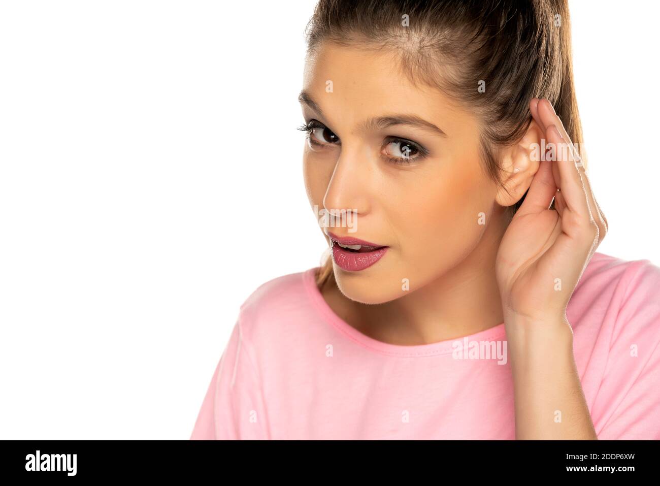 Portrait of young beautiful woman with palm behind her ear on white ...