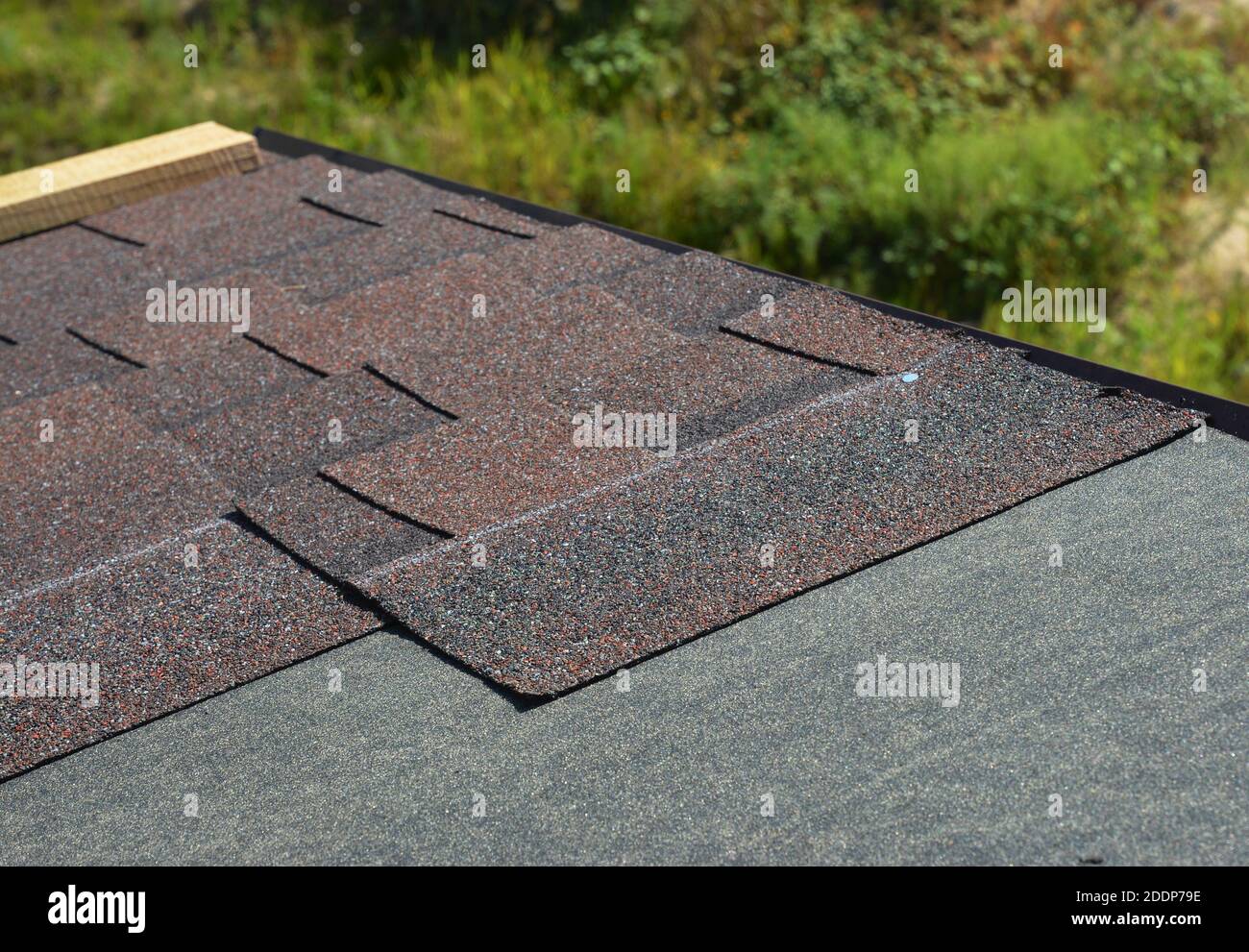 A close-up on brown bitumen, dimensional, or architectural asphalt ...