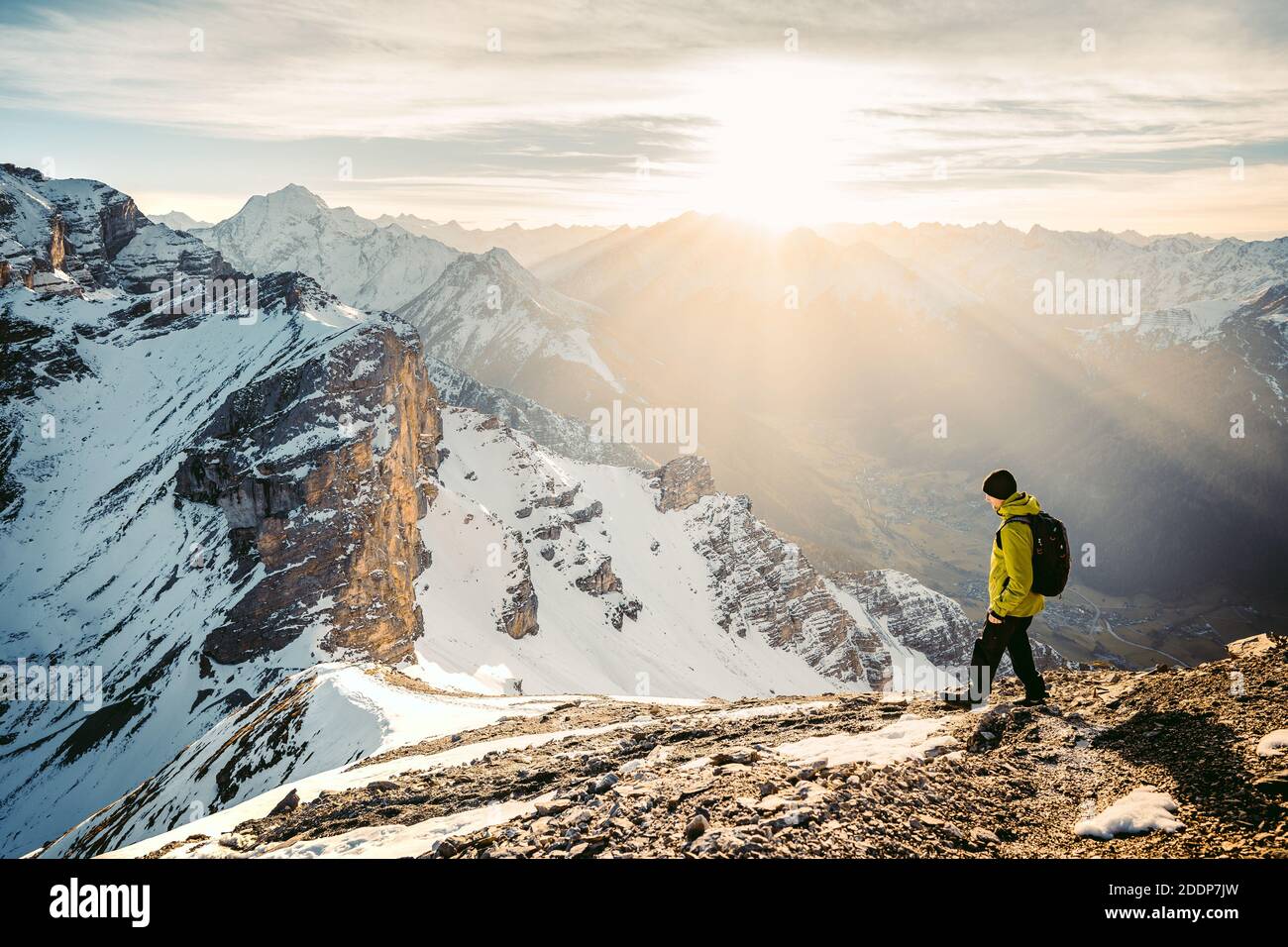 Active climber backpacker man with yellow jacket and backpack climbing ...