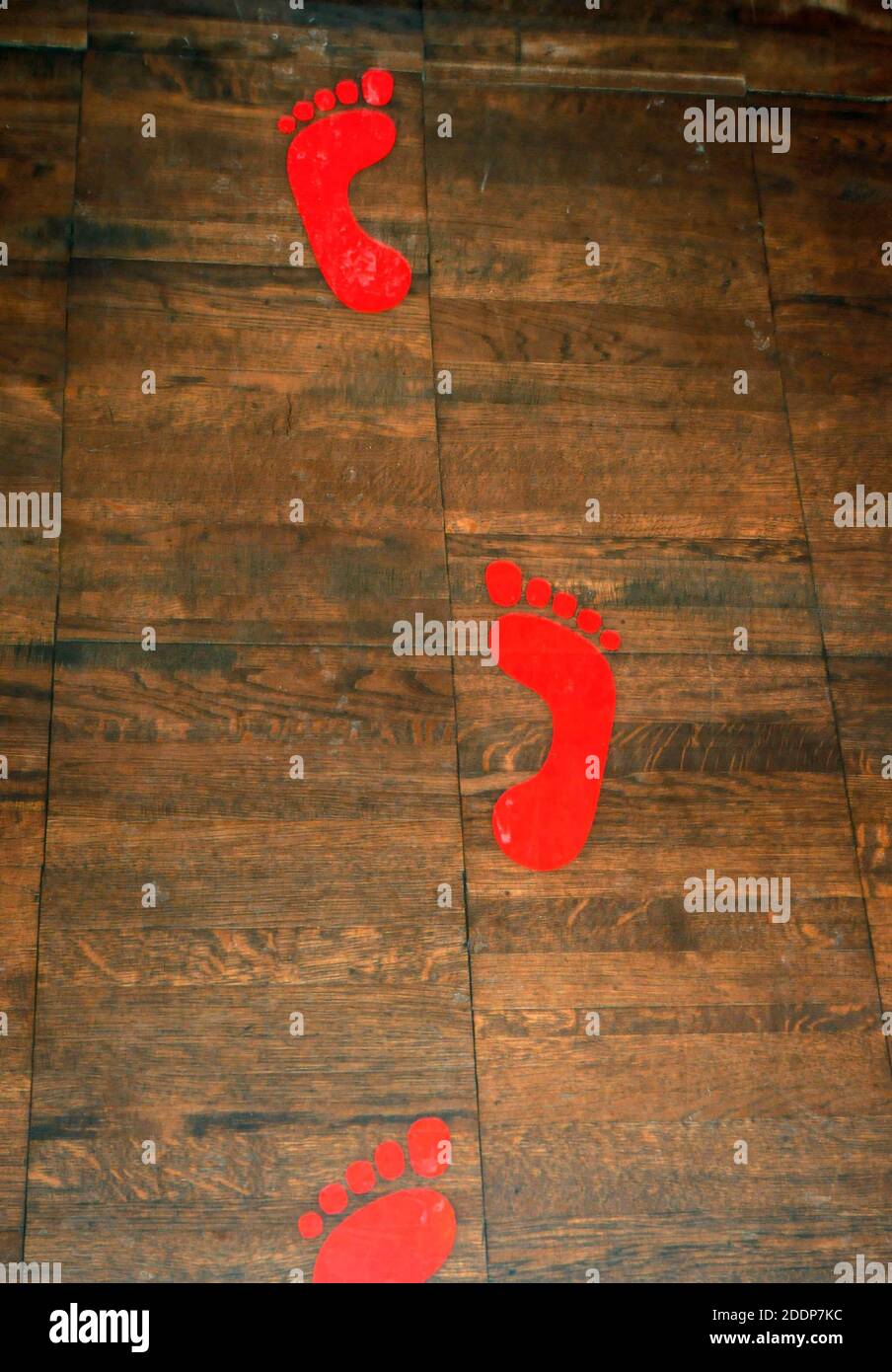 cut out red footprints on a wooden floor, barefoot symbol Stock Photo ...