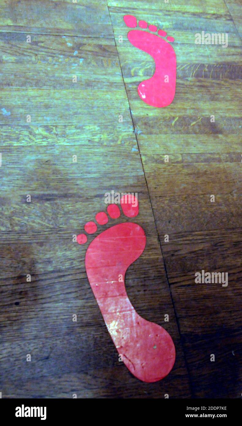 cut out red footprints on a wooden floor, barefoot symbol Stock Photo ...