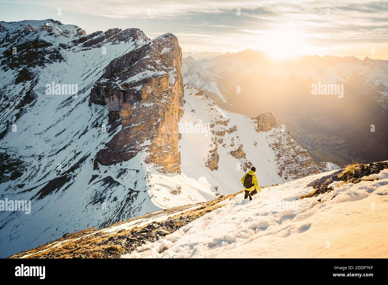 Active climber backpacker man with yellow jacket and backpack climbing ...
