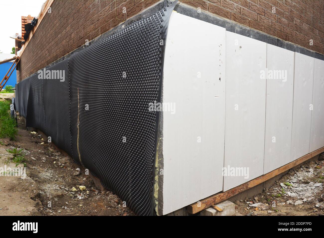 A close up on an external foundation wall of a brick house with ...