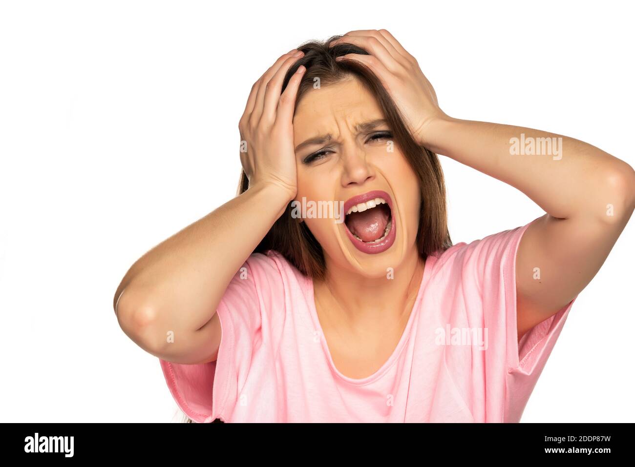 Young woman with strong headache on white background Stock Photo - Alamy
