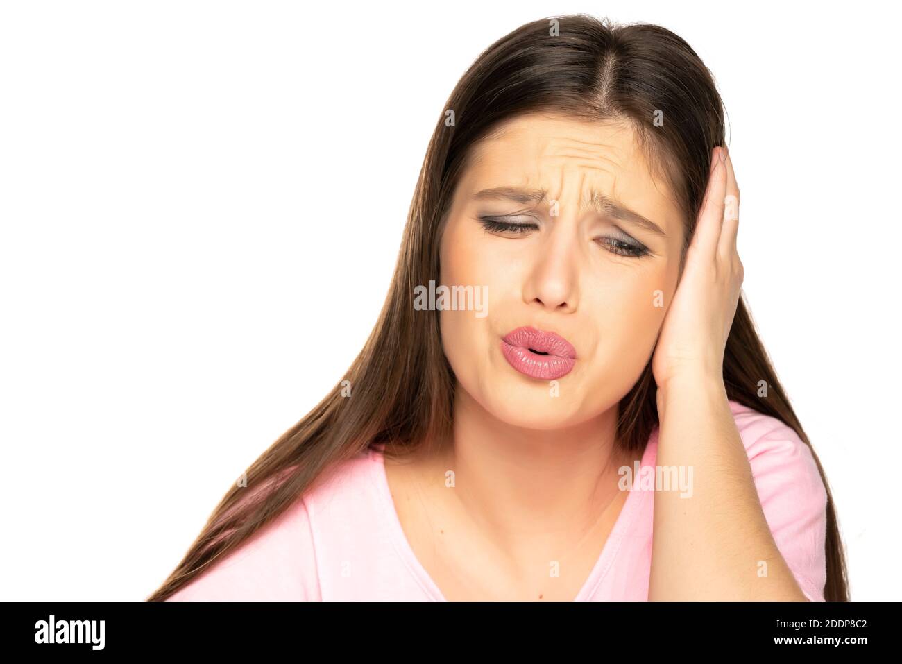 Young woman with strong ear ache on white background Stock Photo - Alamy