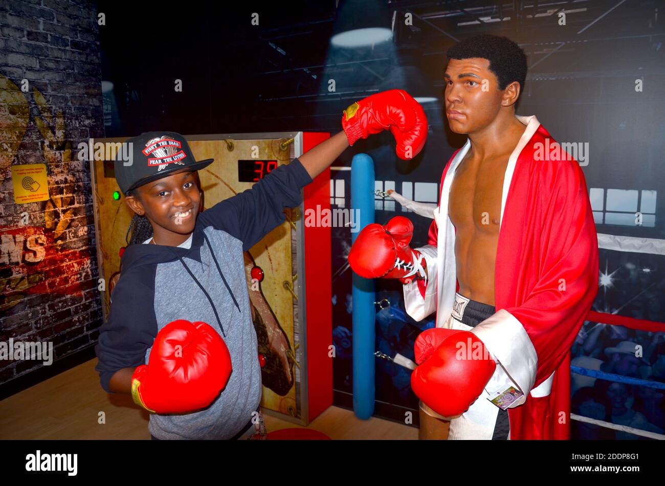 Afro-Caribbean girl posing with Muhammad Ali's wax figure at Madame ...