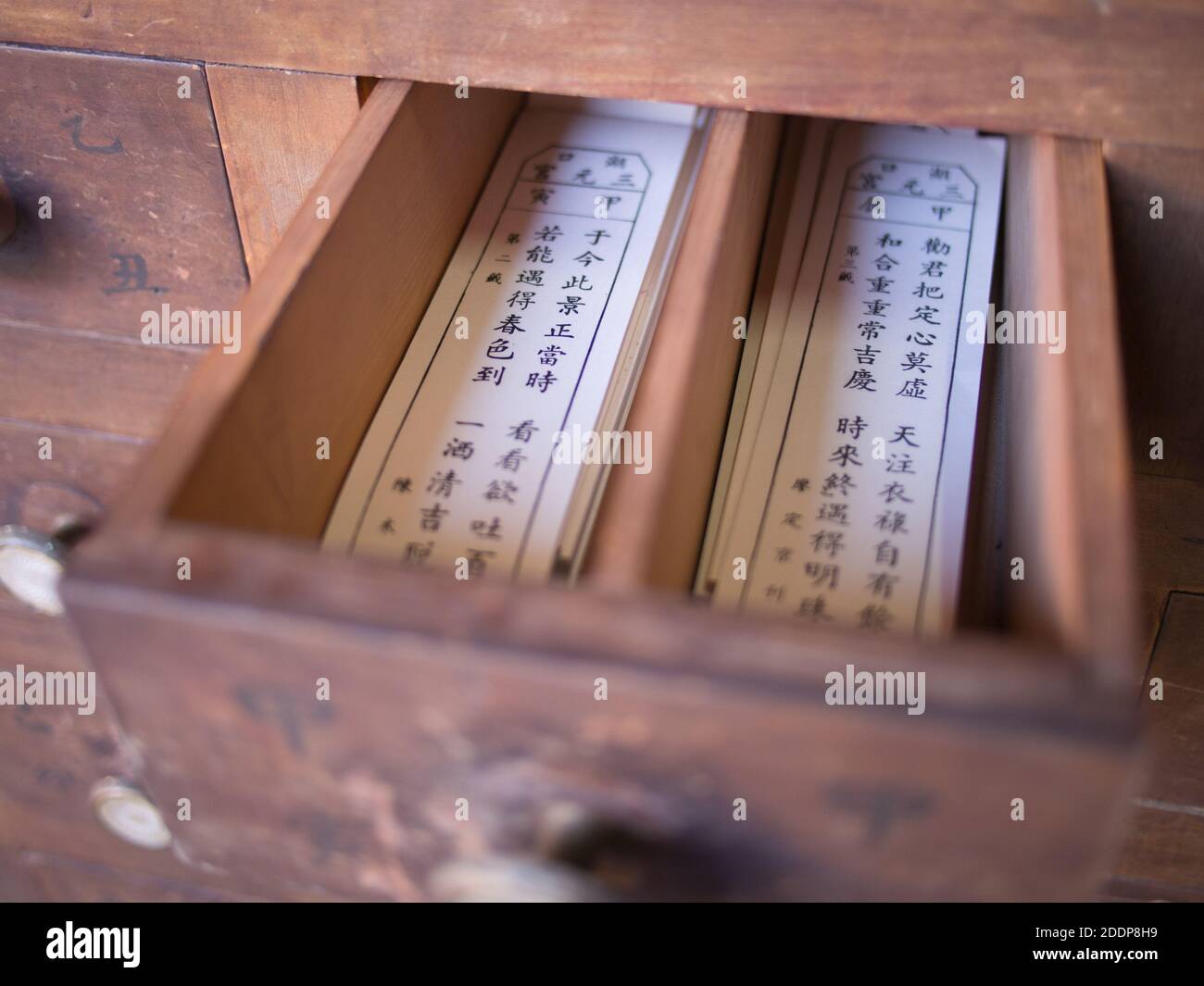 Fortune telling oracle slips stored in a wooden drawer at Hukou Sanyuan ...