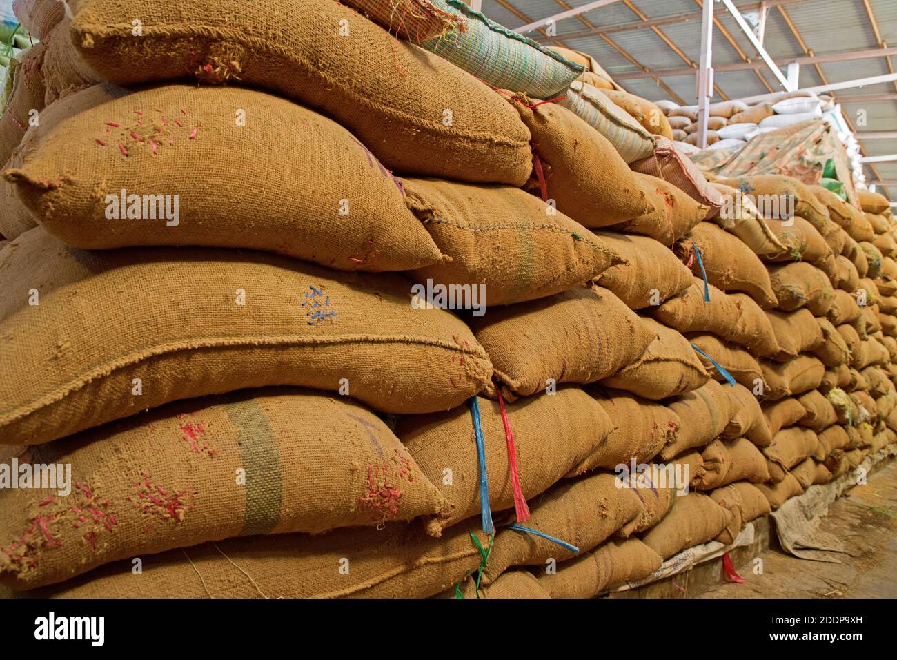 Warehouse and Sacks stacked Stock Photo - Alamy