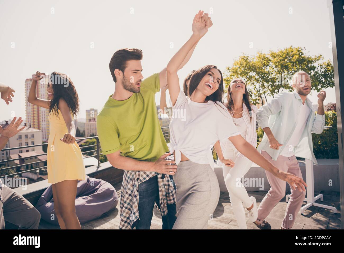Photo of friendly pretty couples have fun dancing party on roof terrace ...