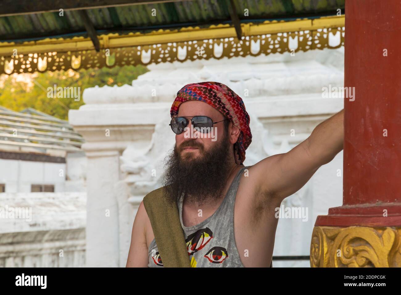 Man with a beard wearing glasses and headscarf at Kuthodaw Pagoda ...